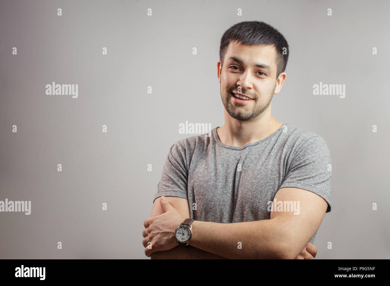 kind sportsman is standing with folded arms. personal fitness trainer ...