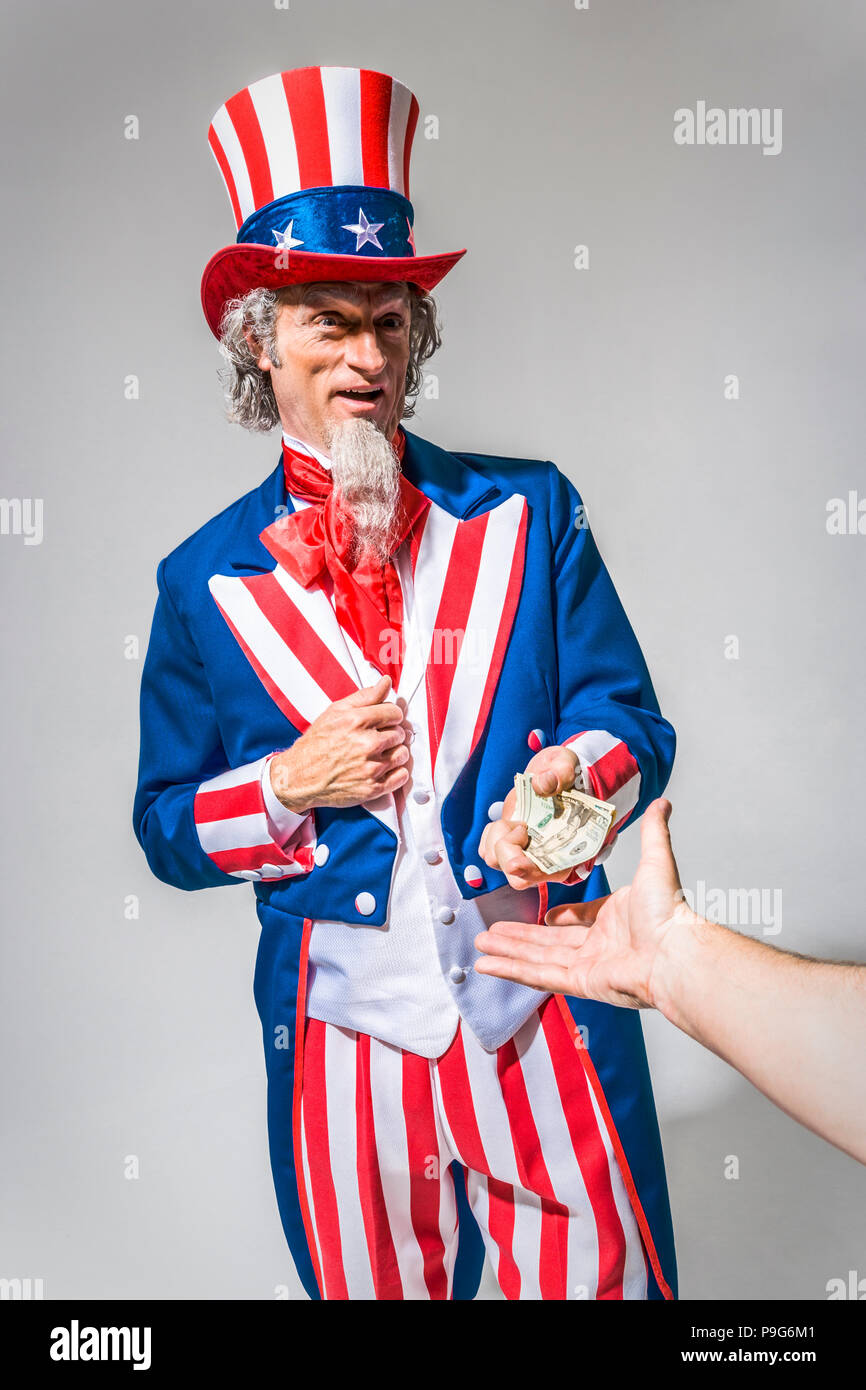 Uncle Sam taking money. Concept of corruption / payoffs, government ...