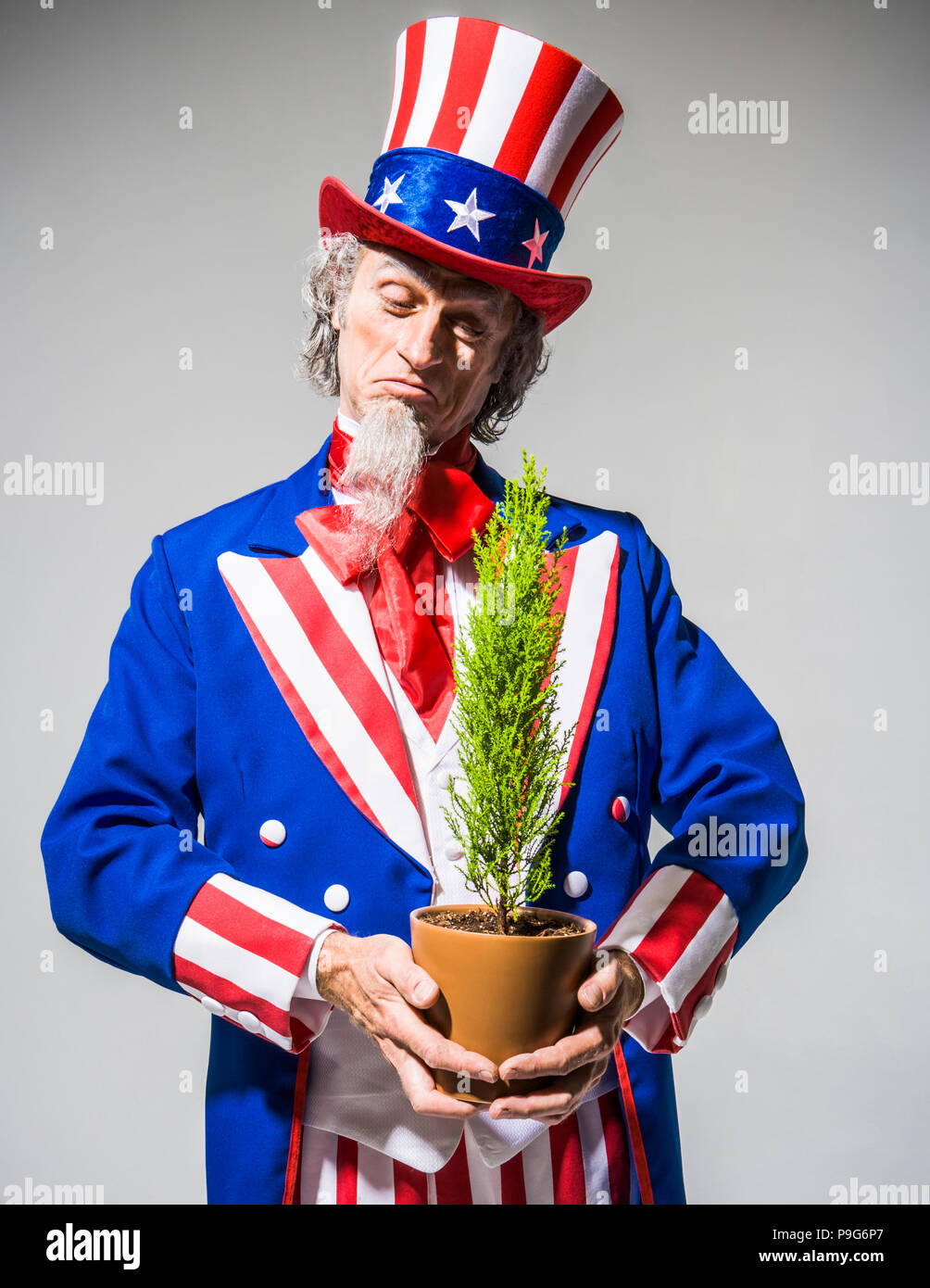 Uncle Sam character holding a small green potted plant / tree. Concept ...