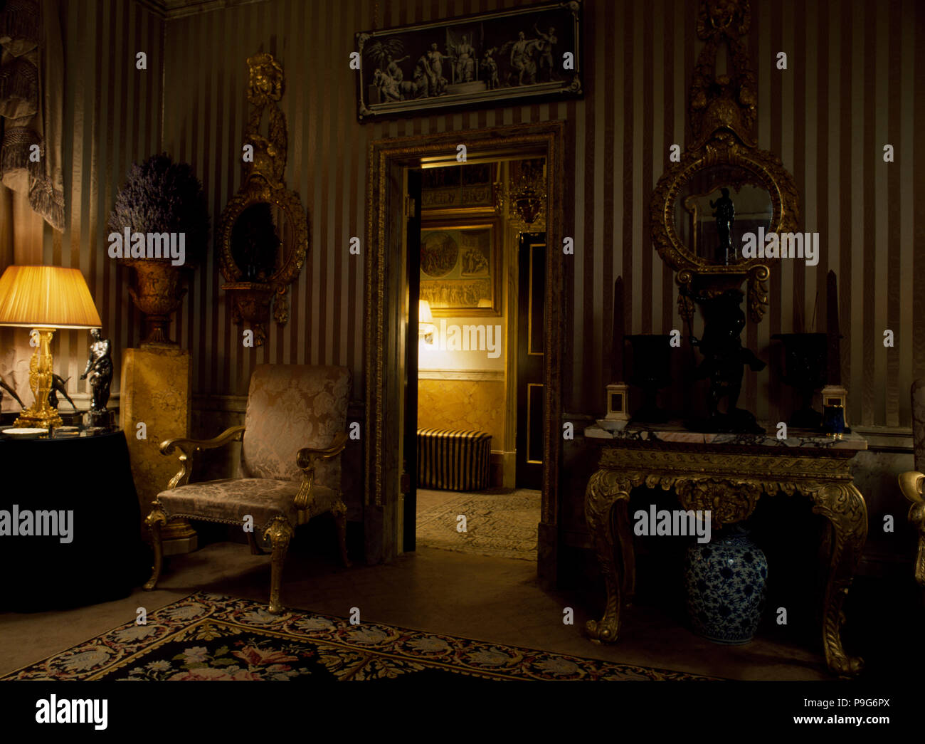 Antique gilt furniture and striped wallpaper in Regency style room ...