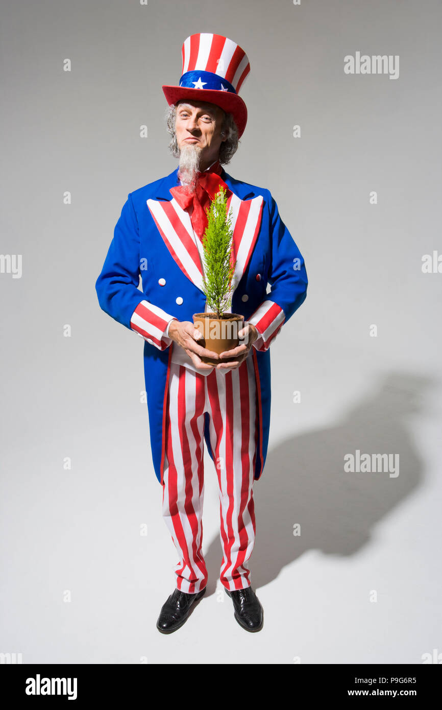 Uncle Sam character holding a small green potted plant / tree. Concept ...
