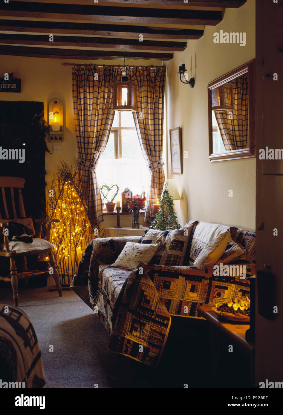 Patchwork throw on sofa in cottage living room with Christmas tree ...