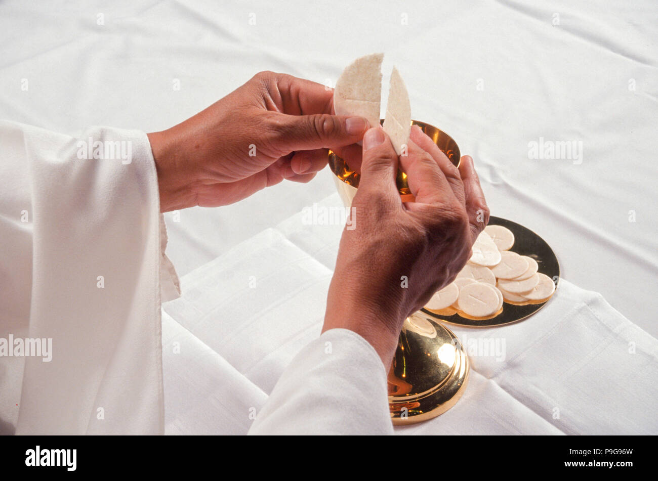 Communion priest breaking host wafer communion MR © Myrleen Pearson ...