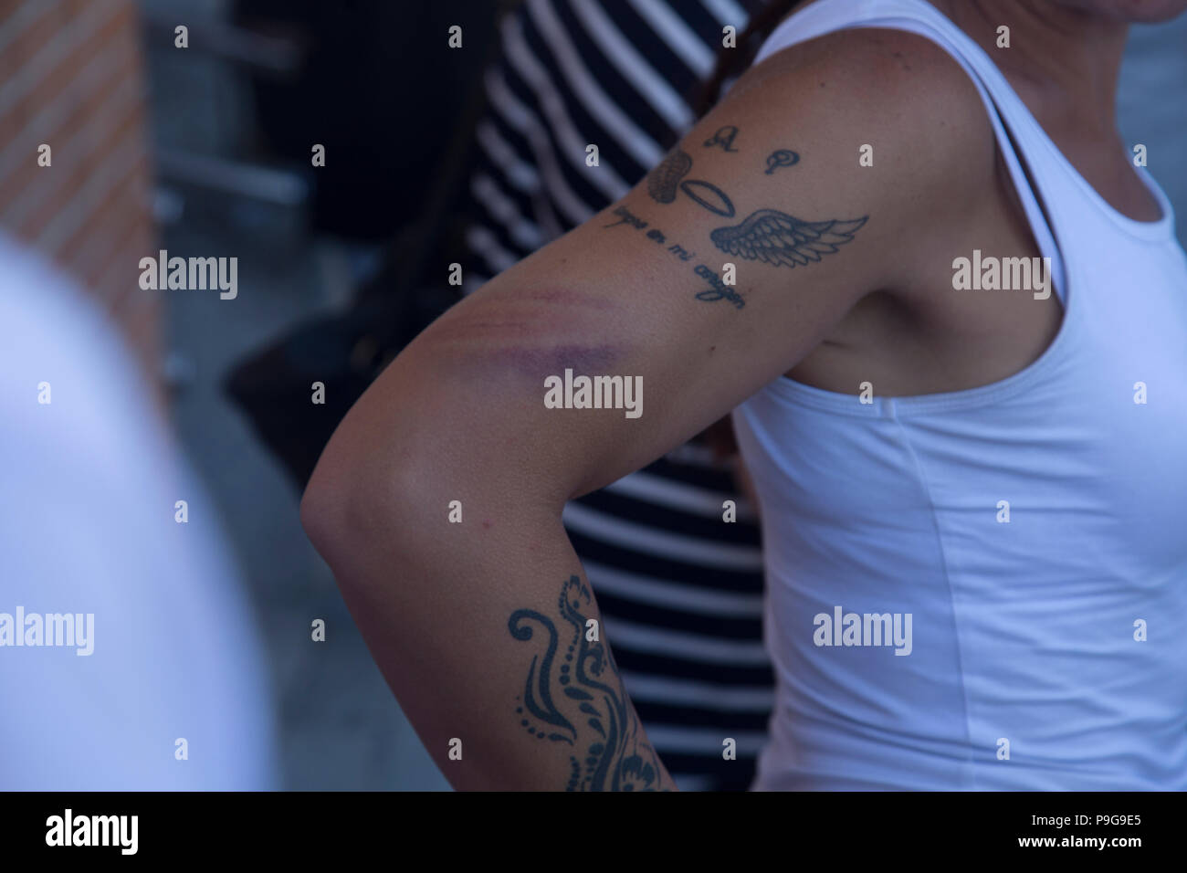 A protester shows her wound after being hit by the batons during the ...