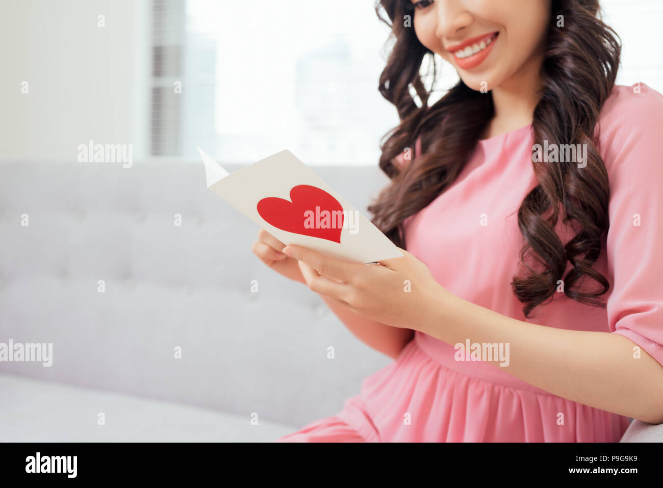 Cute girl reading a love card from her boyfriend Stock Photo - Alamy