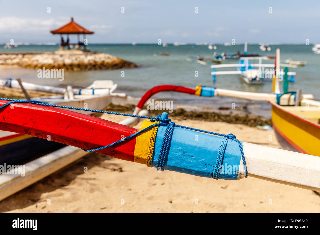 Traditional Indonesian outrigger style wooden fishing boat (jukung) on ...