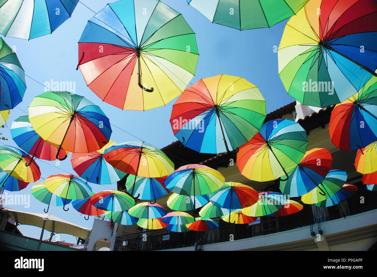Group of colorful umbrellas above the street in the sky Stock Photo - Alamy