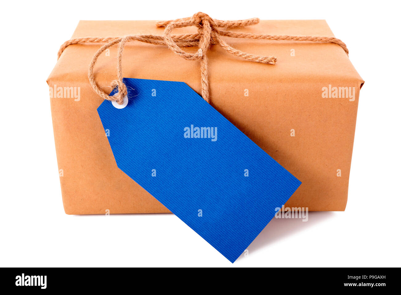 Plain brown paper package or parcel, blue gift tag or label and ribbon ...