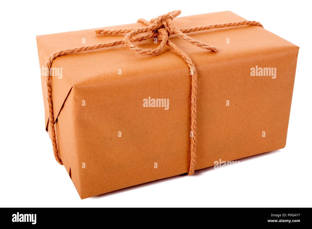 Plain brown paper parcel or package tied with thick rope isolated on ...