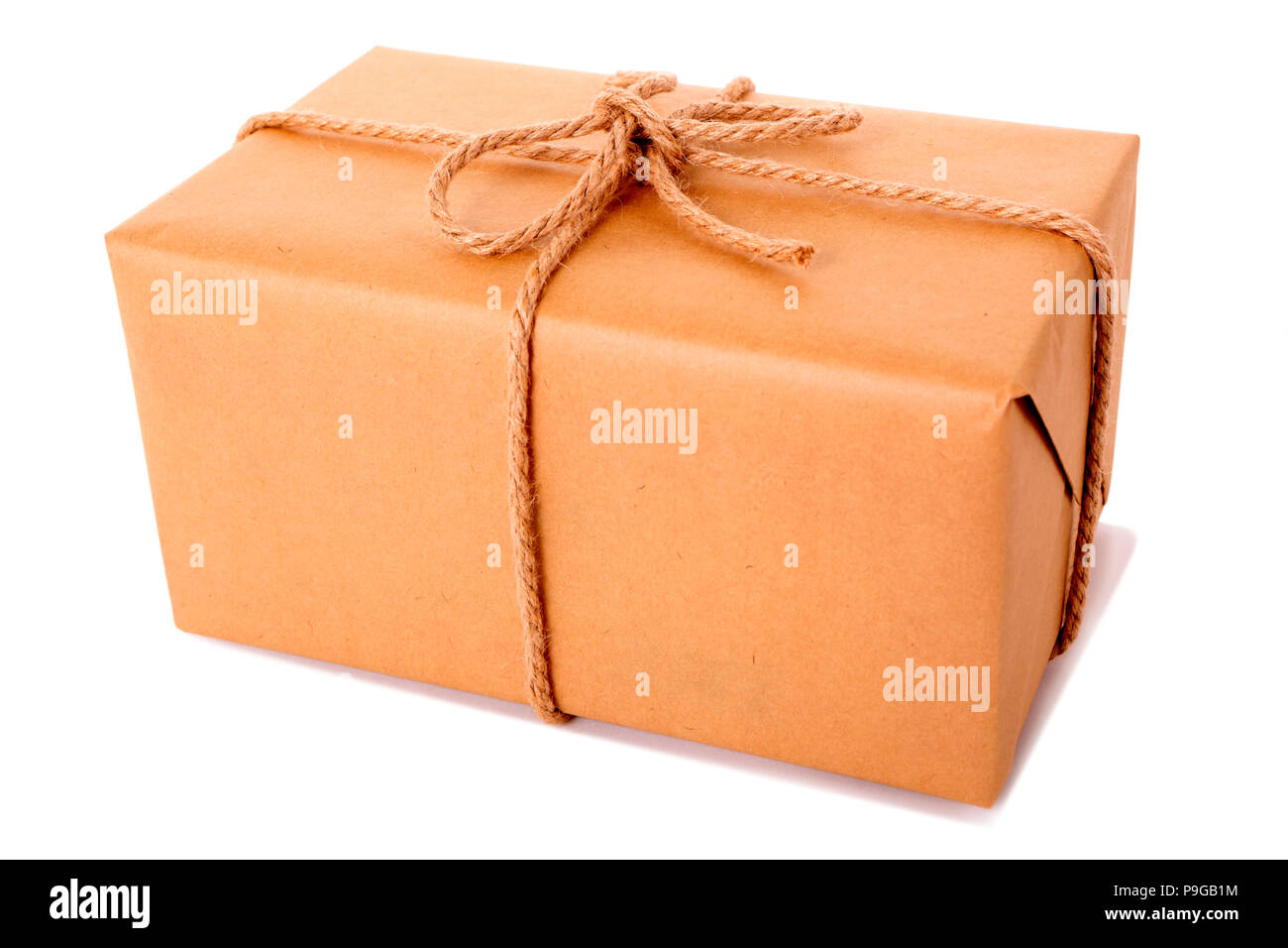 Plain brown paper parcel or package tied with thick rope isolated on ...