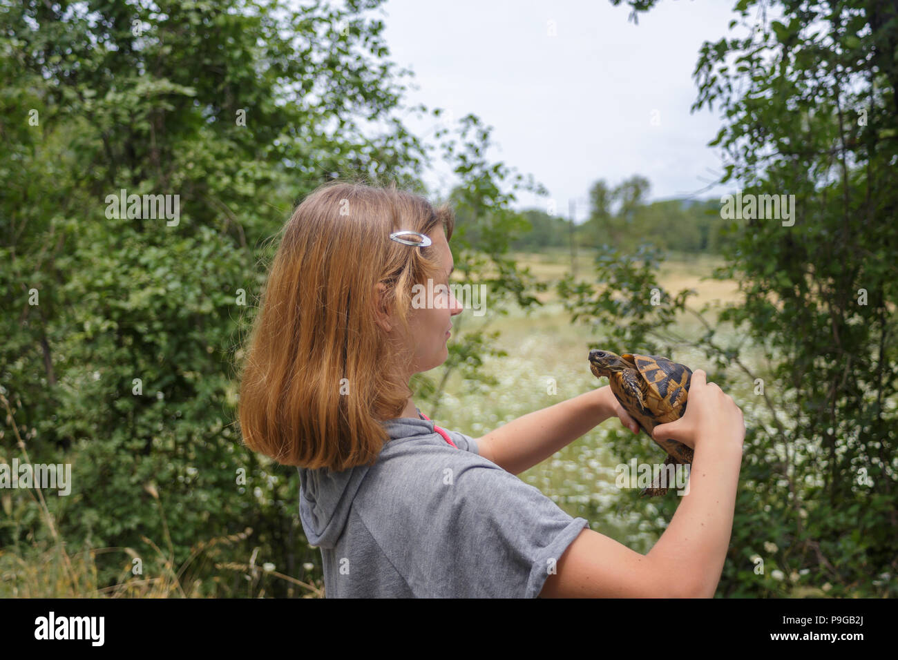 Girl hold the turtle on pakm. girl explores the turtle. friendship with ...