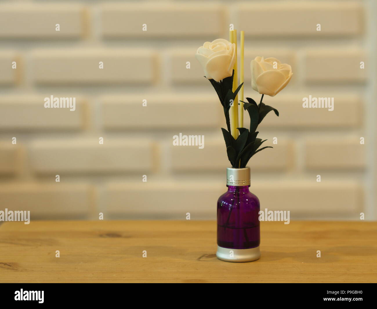 Aroma Incense with a Plastic Flowers with White Brick wall background ...