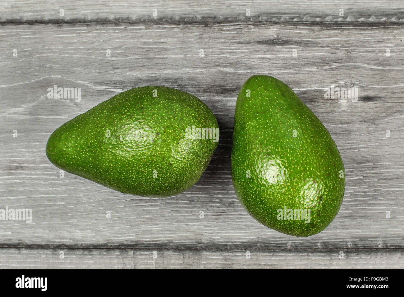 Table top view - two avocado pears on gray wood table Stock Photo - Alamy
