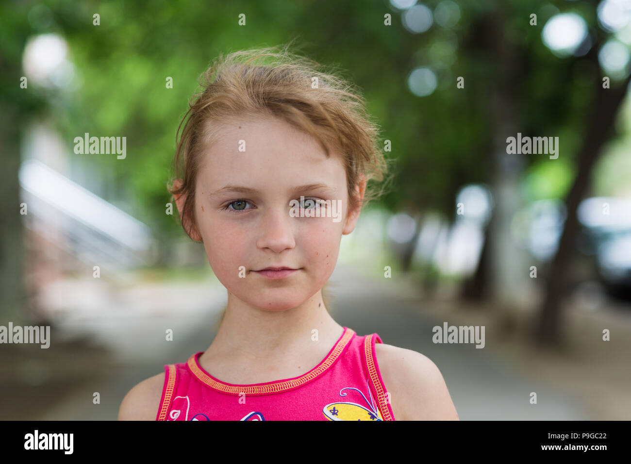 portrait of child girl with a sly look in summer Stock Photo - Alamy