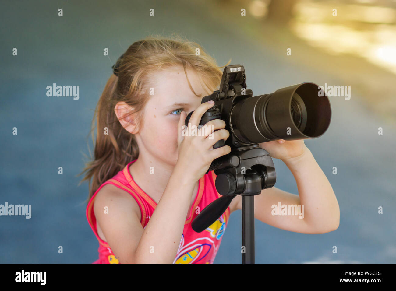 Young child girl photographer uses modern digital photo camera Stock ...