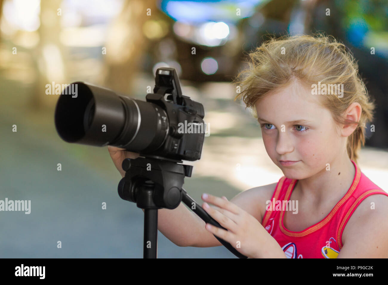 Young child girl photographer uses modern digital photo camera Stock ...