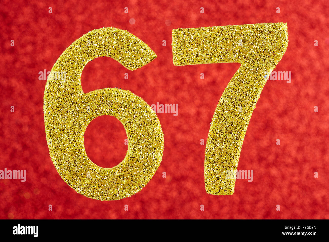 Number sixty-seven gold color over a red background. Anniversary ...