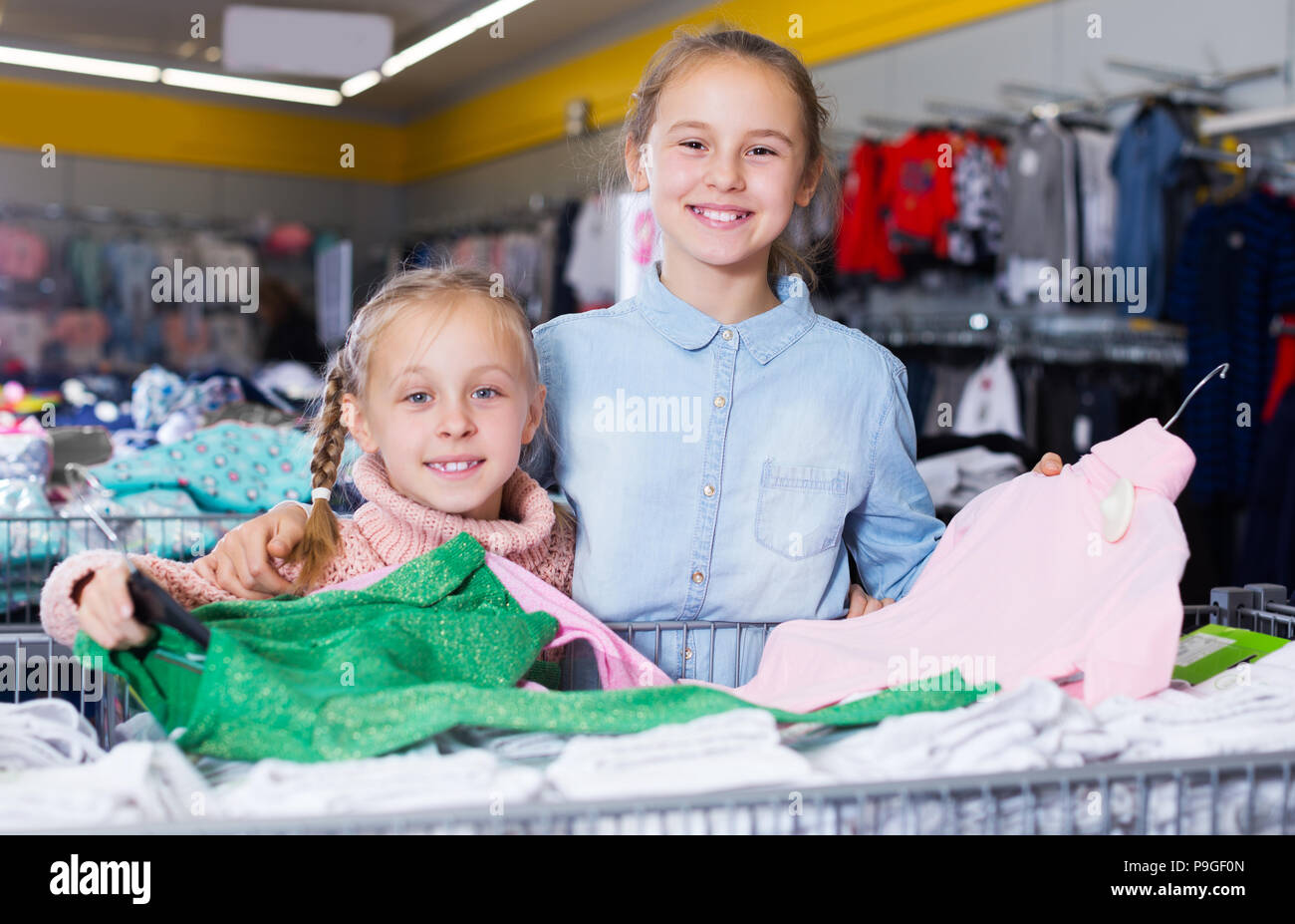 Portrait of two little girls with new clothes in shopping mall Stock ...