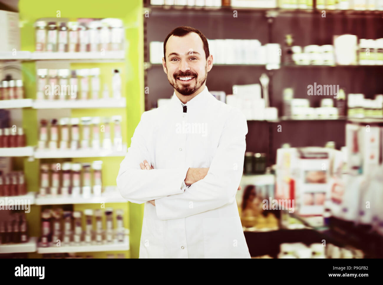 Happy man pharmacist showing assortment of drugs in pharmacy Stock ...