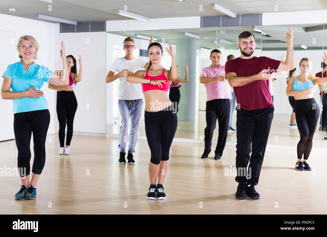 positive sporty adults of different ages dancing at dance class Stock ...