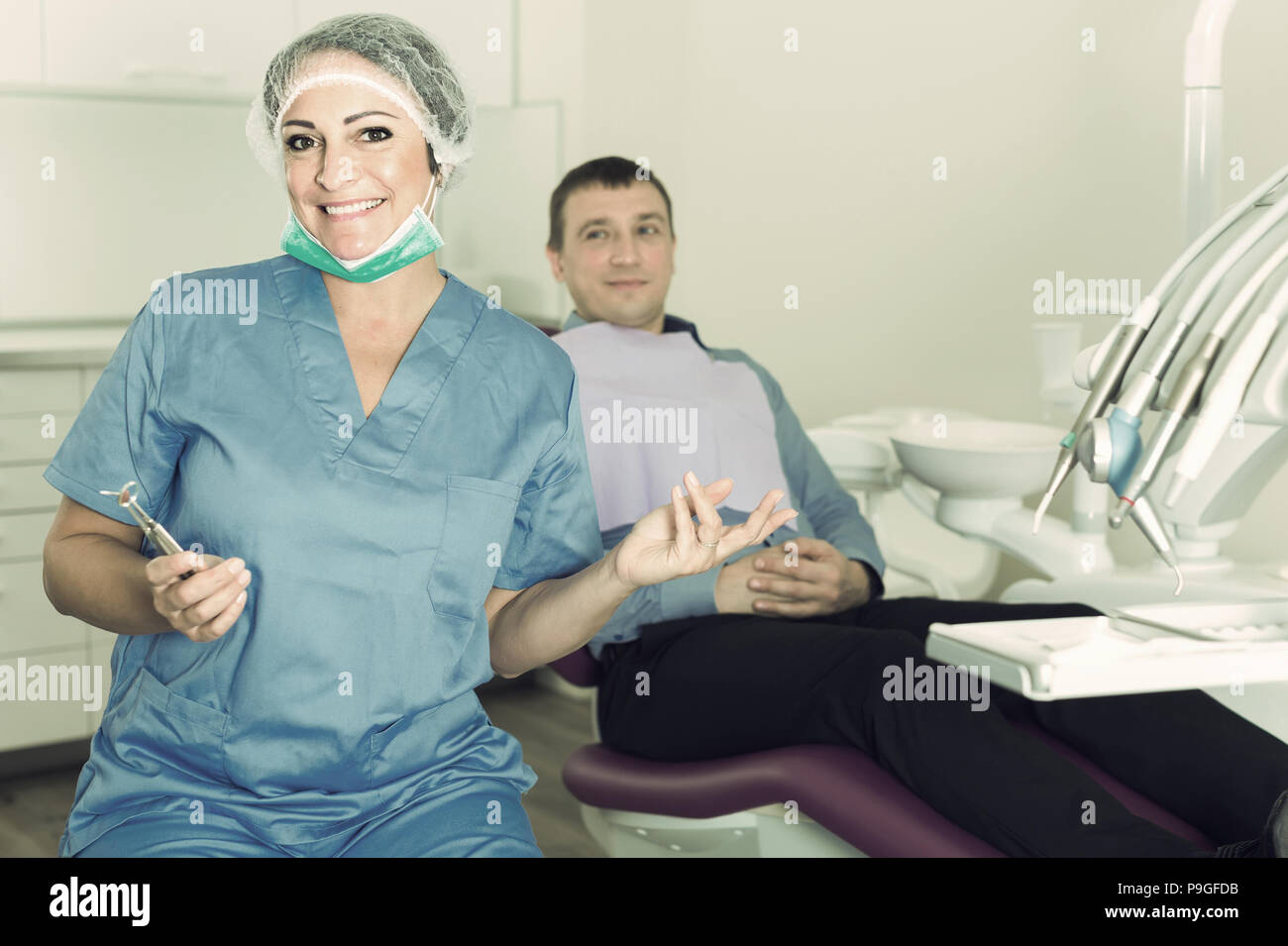 professional positive doctor woman and patient sitting in medical chair ...
