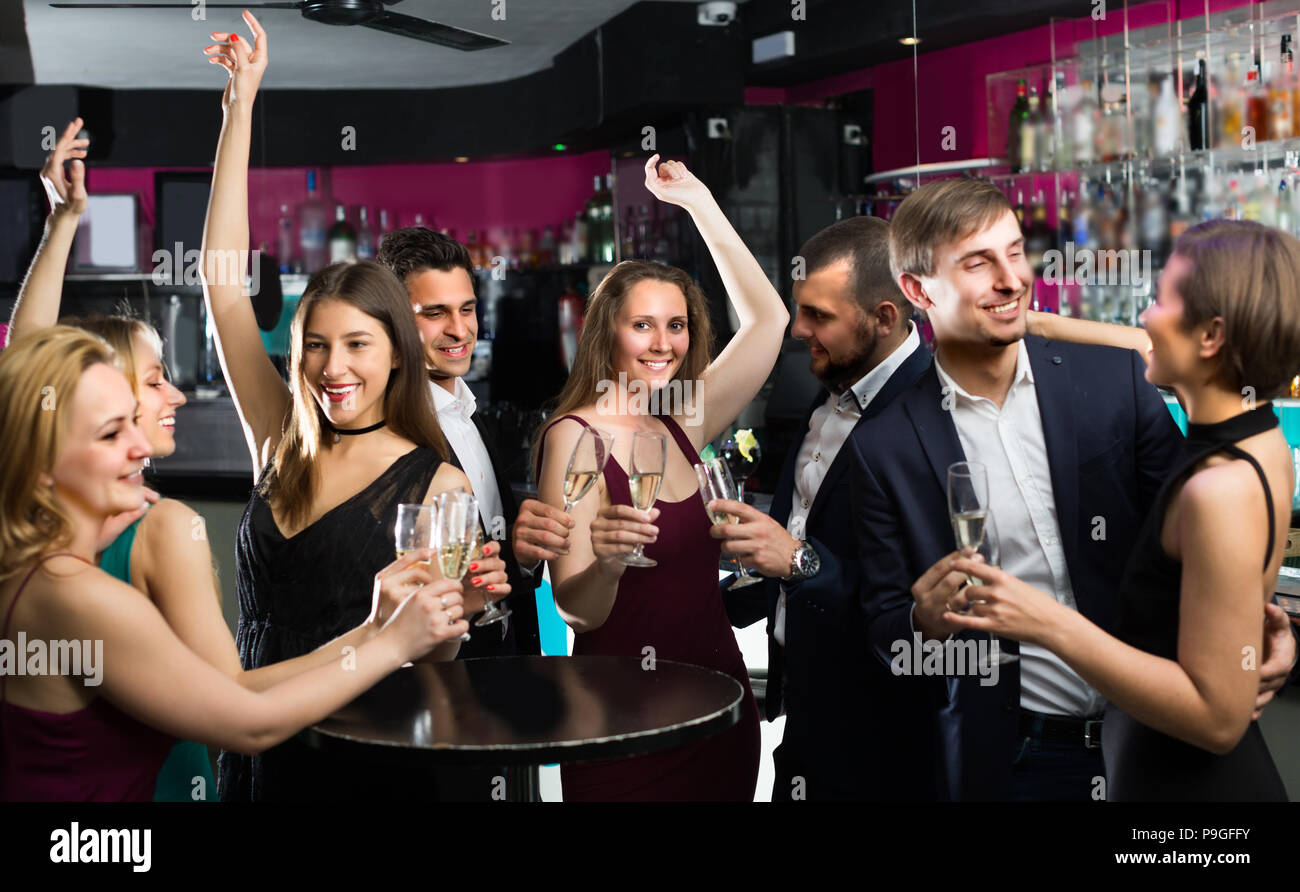 Cheerful people are resting and drinking cocktails on the corporate ...
