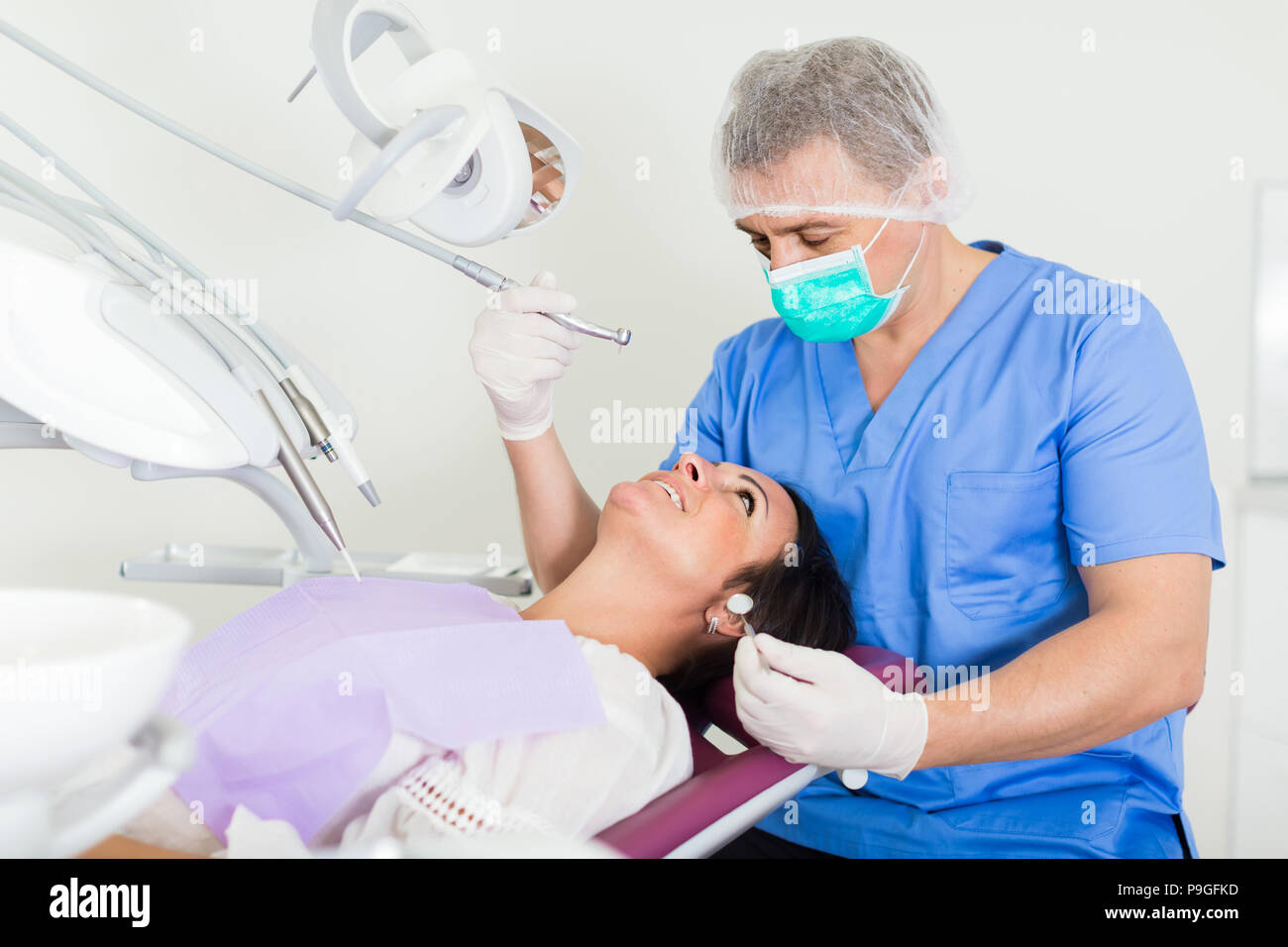 dentist professional filling teeth woman patient sitting in medical ...