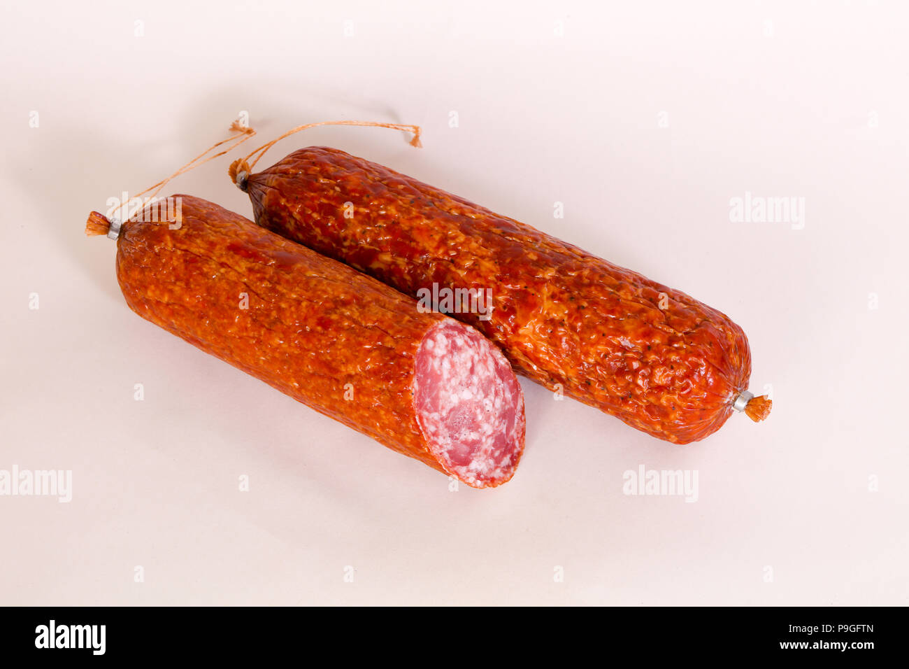 Two Salamy sausages isolated Stock Photo - Alamy