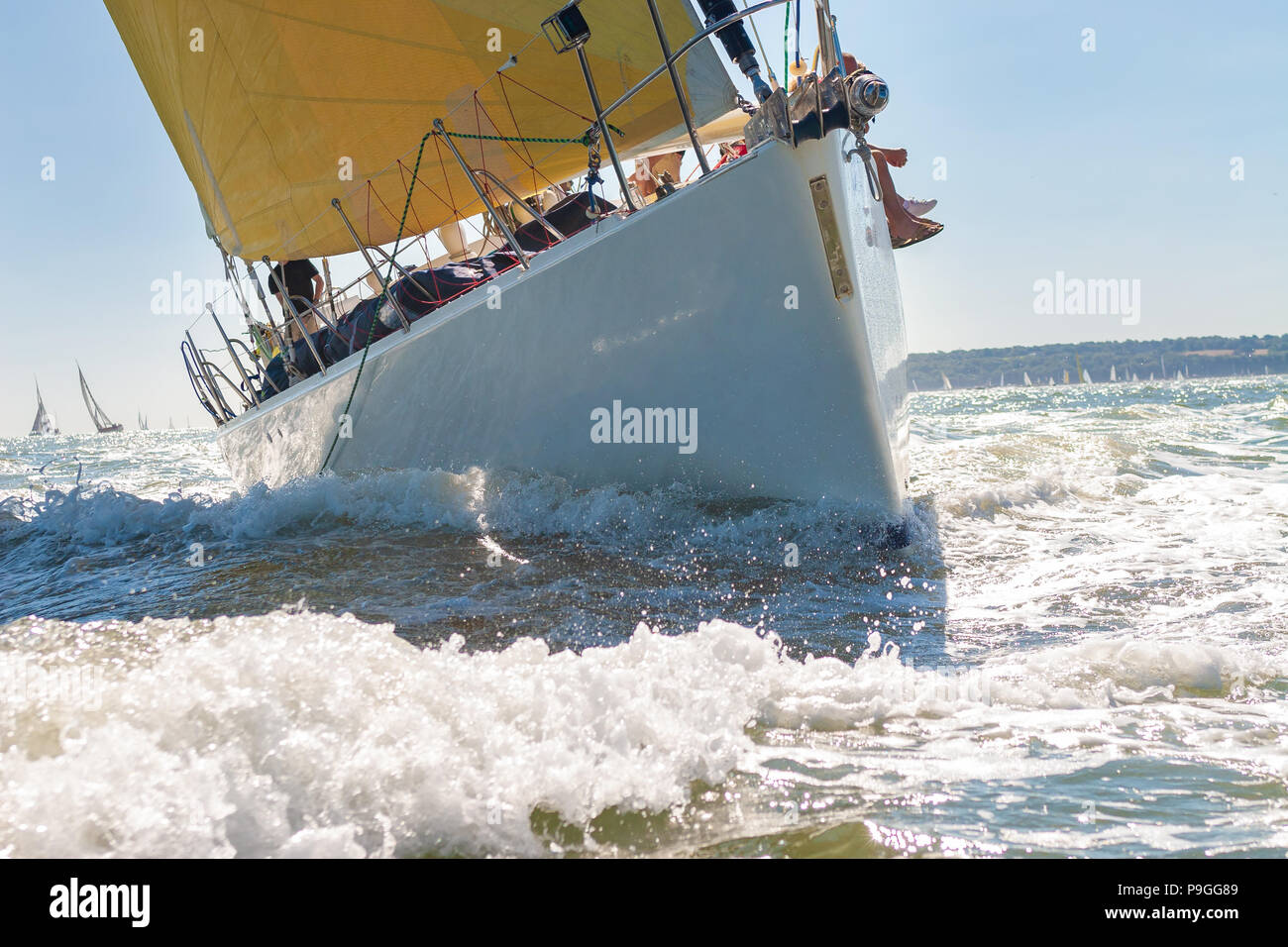 Close up of sailing boat, sail boat or yacht at sea with yellow sails ...