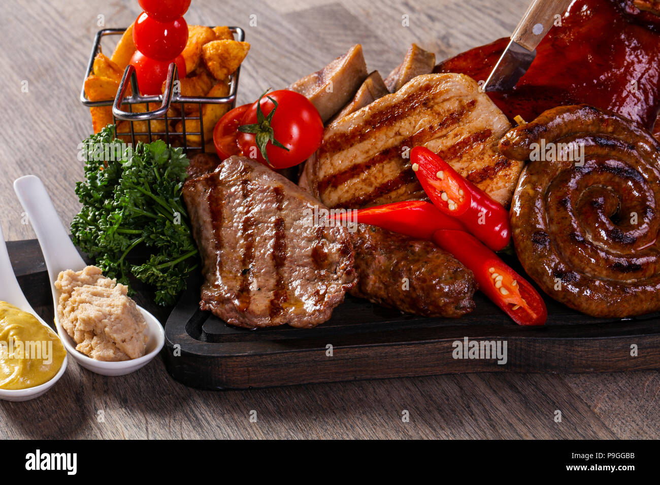 Grilled meat mix plate - beef, pork and chicken Stock Photo - Alamy