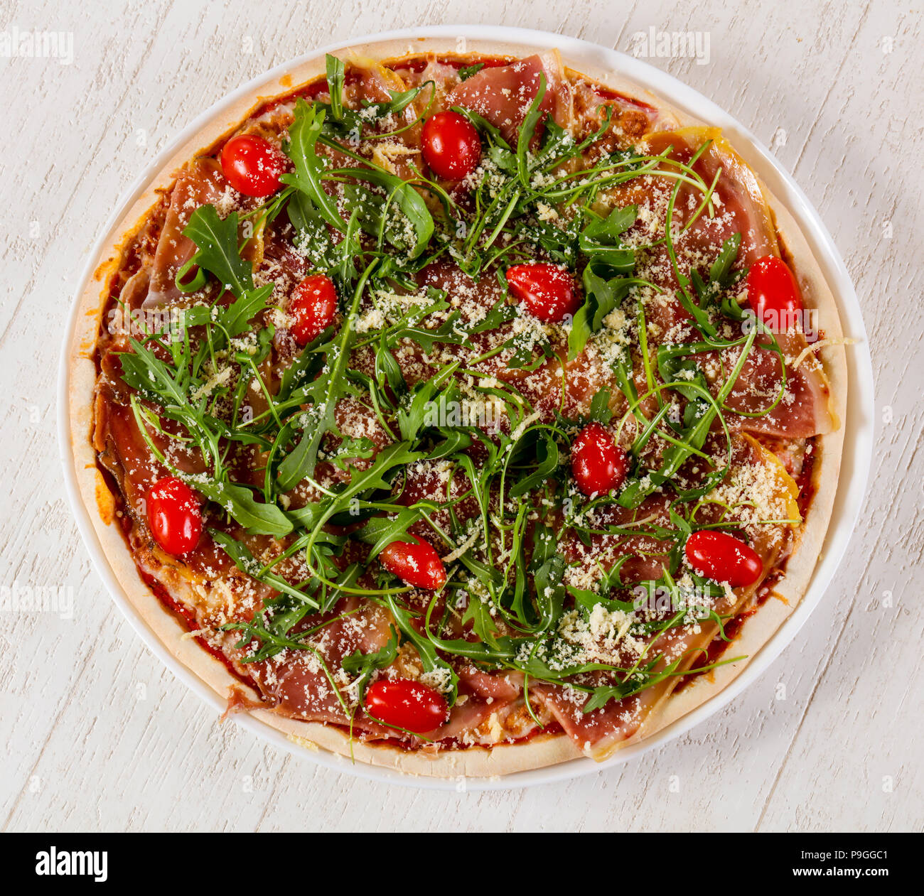 Pizza with hamon and ruccola Stock Photo - Alamy
