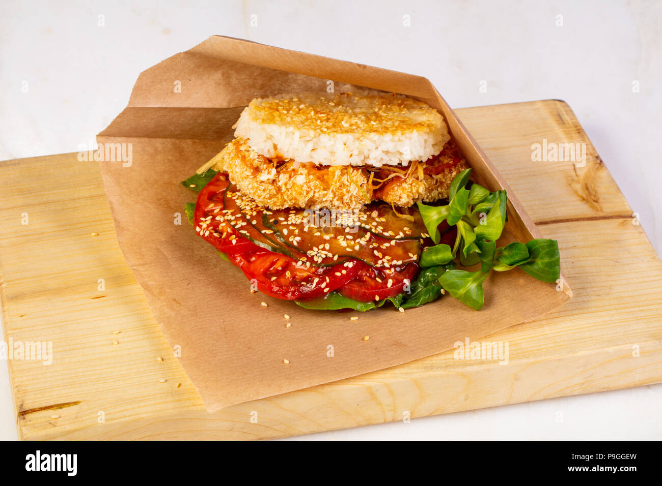 Rice burger with crispy chicken Stock Photo - Alamy