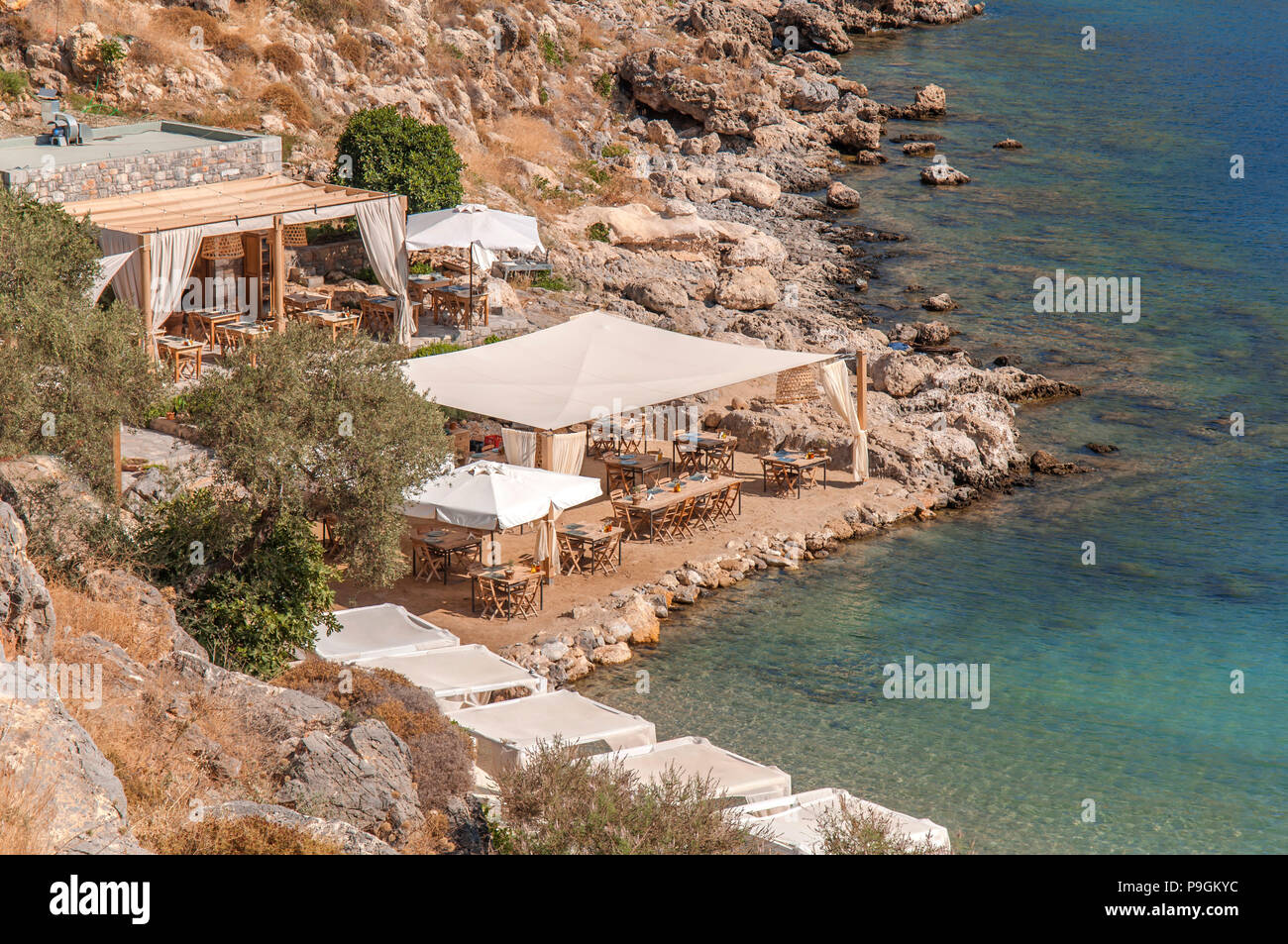 Tropical summer beach bar restaurant with white baldachins and sea ...