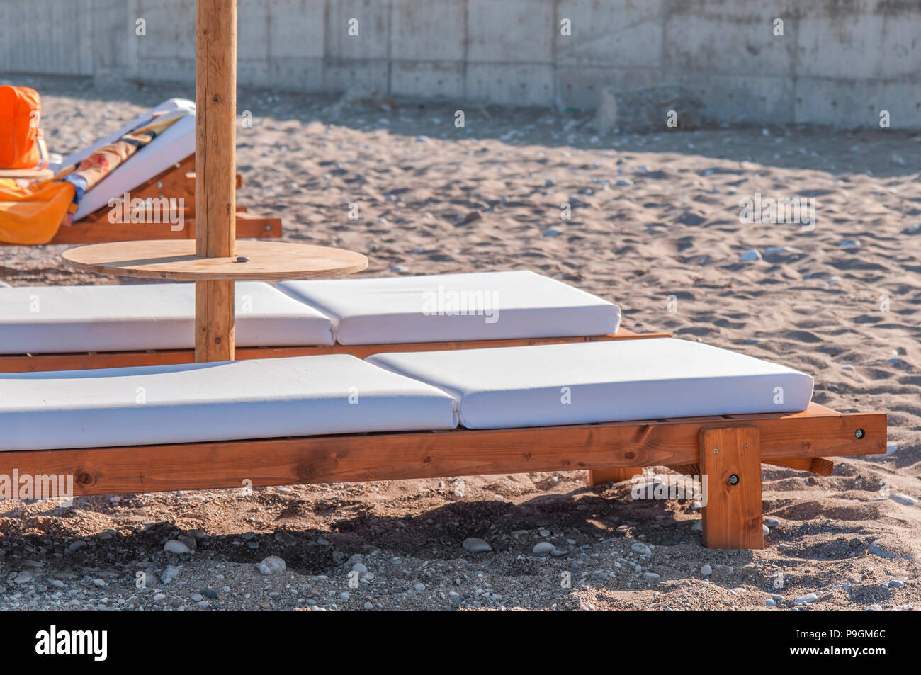 Two empty sun bed at small pebble stone beach for relaxation Stock ...