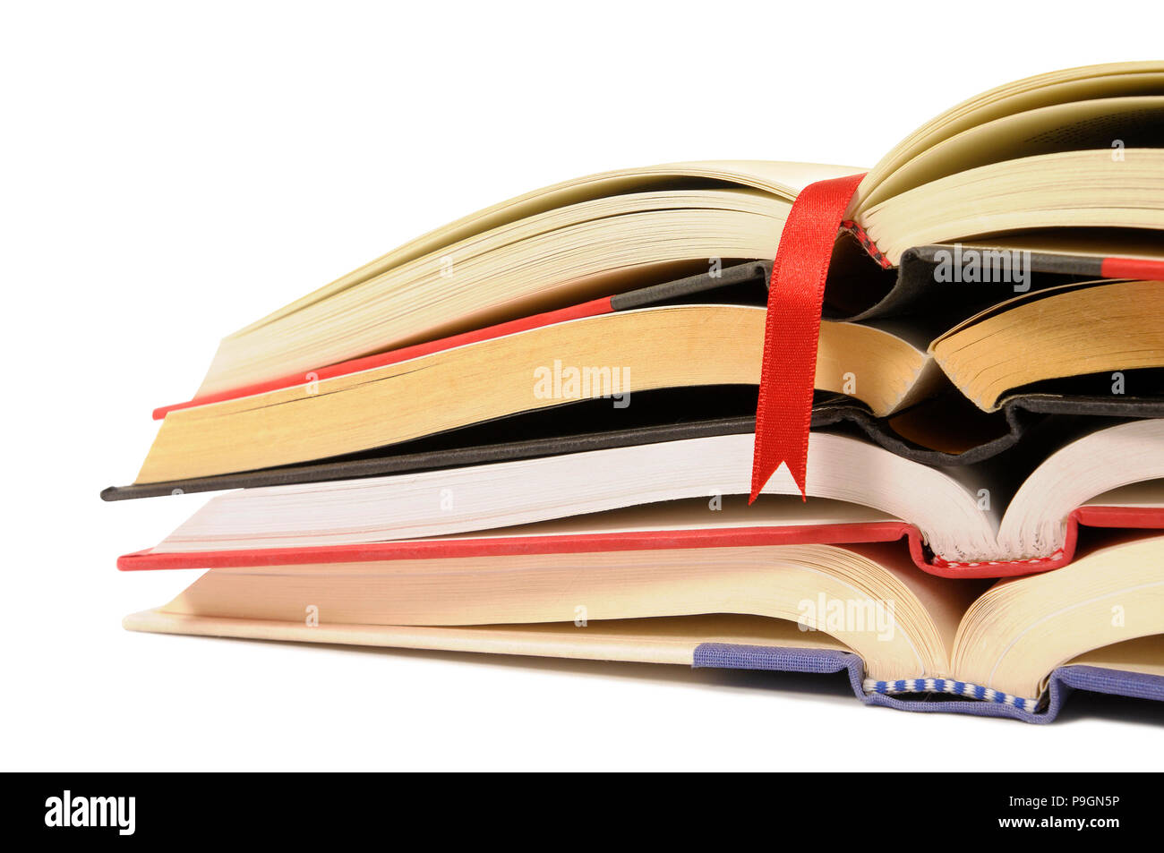 Small pile of open books with red bookmark ribbon isolated on white ...