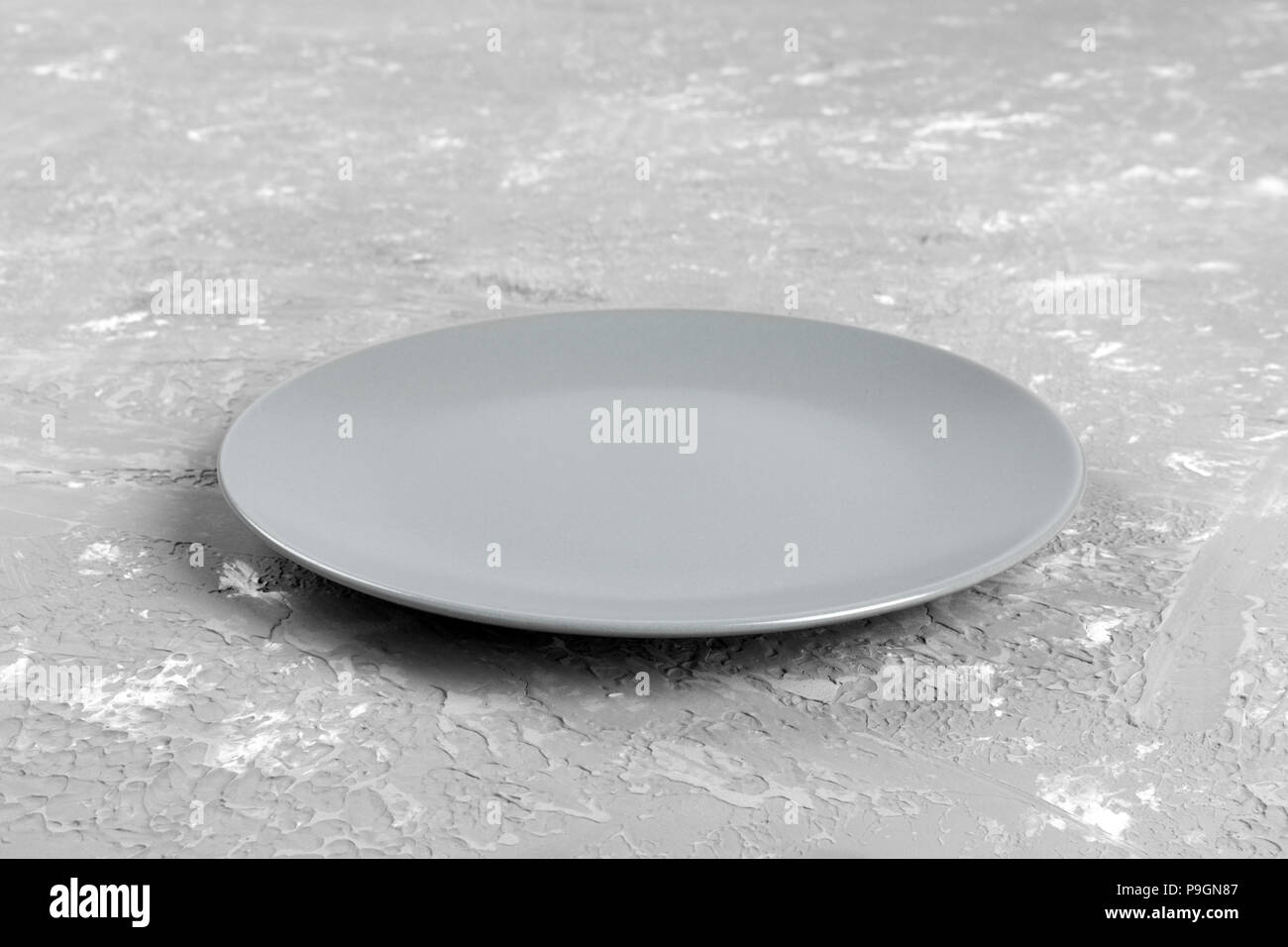 Empty plate on cement background. perspective view Stock Photo - Alamy