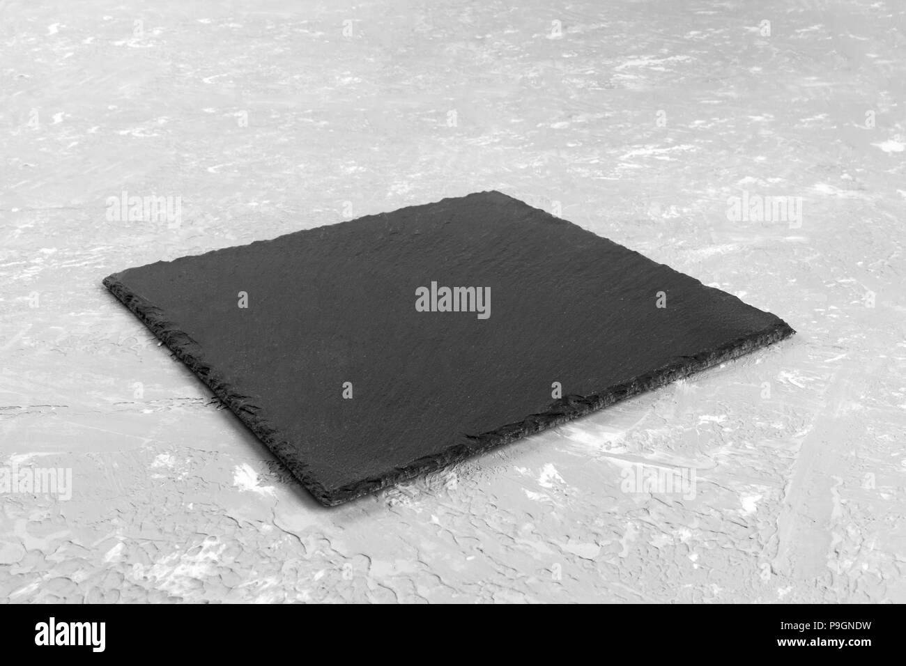 traditional japanese square empty black slate plate on grey textured ...