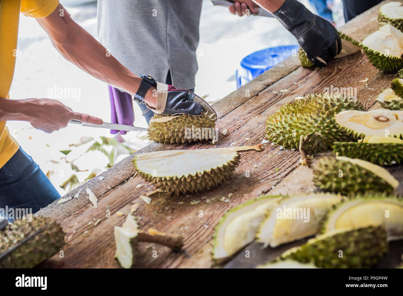 peeling durian by knife. Thai King fruit Stock Photo - Alamy