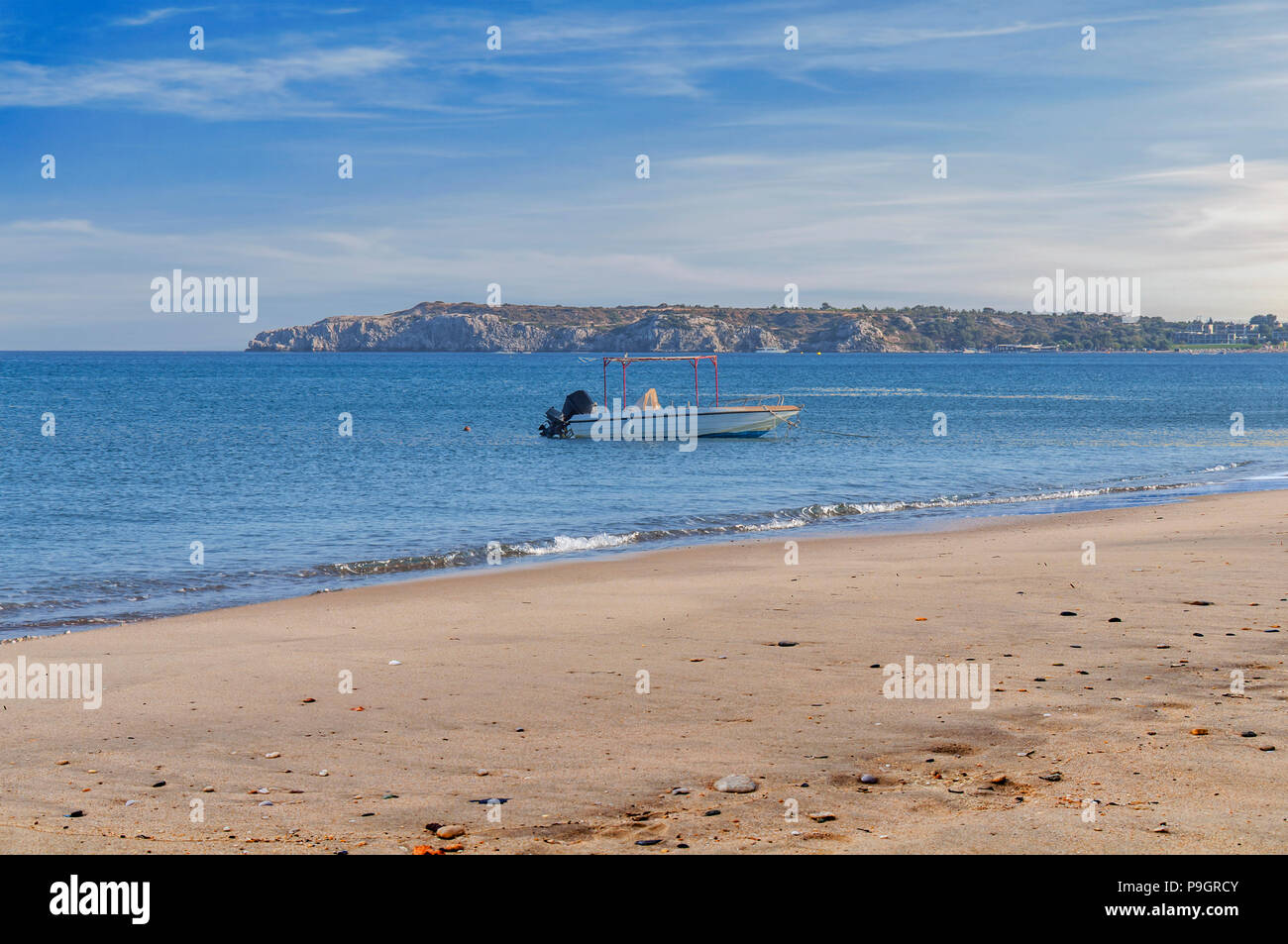 Small boat docked on sea beach with sky background Stock Photo - Alamy