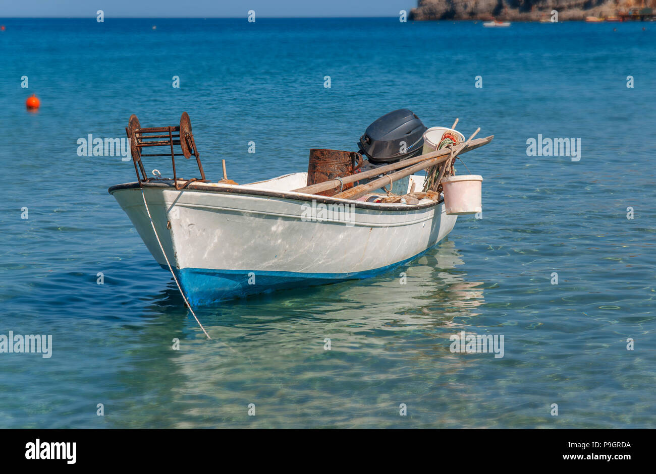 Small white fish boat at blue sea docked and ready for fishing Stock ...