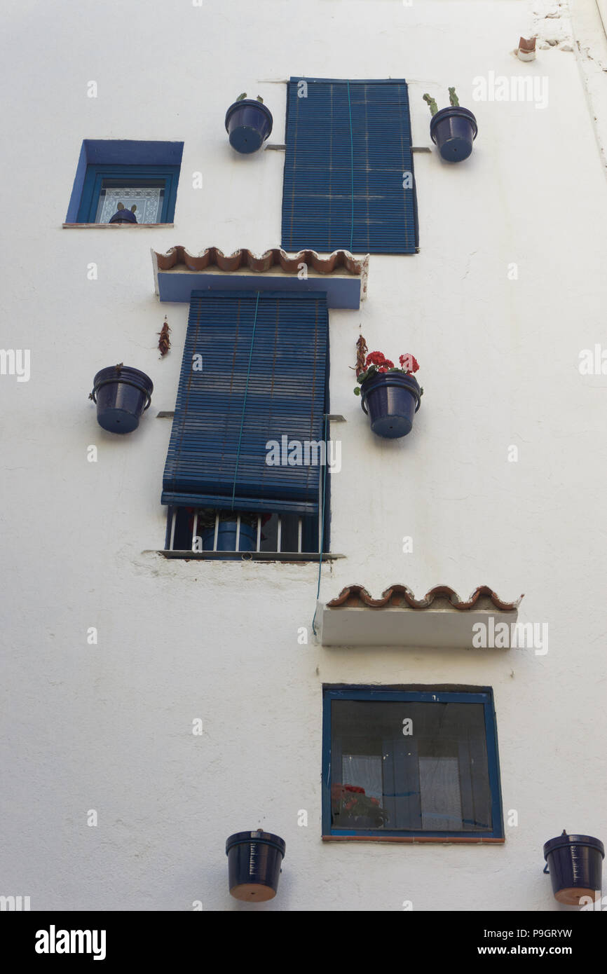 front view of white building with blue doors or windows Stock Photo - Alamy
