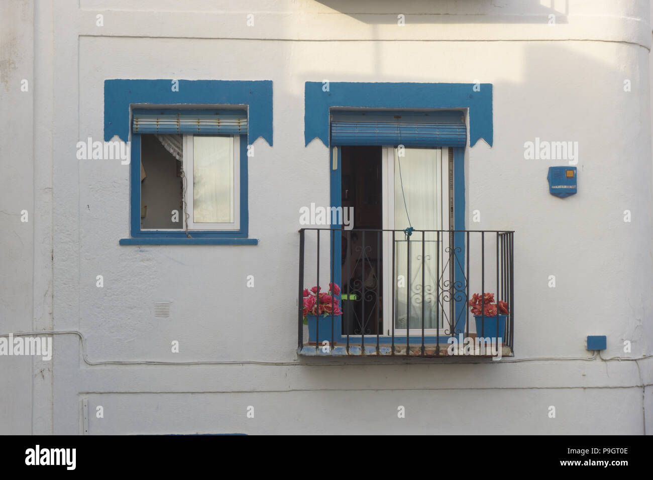 front view of white building with blue doors or windows Stock Photo - Alamy