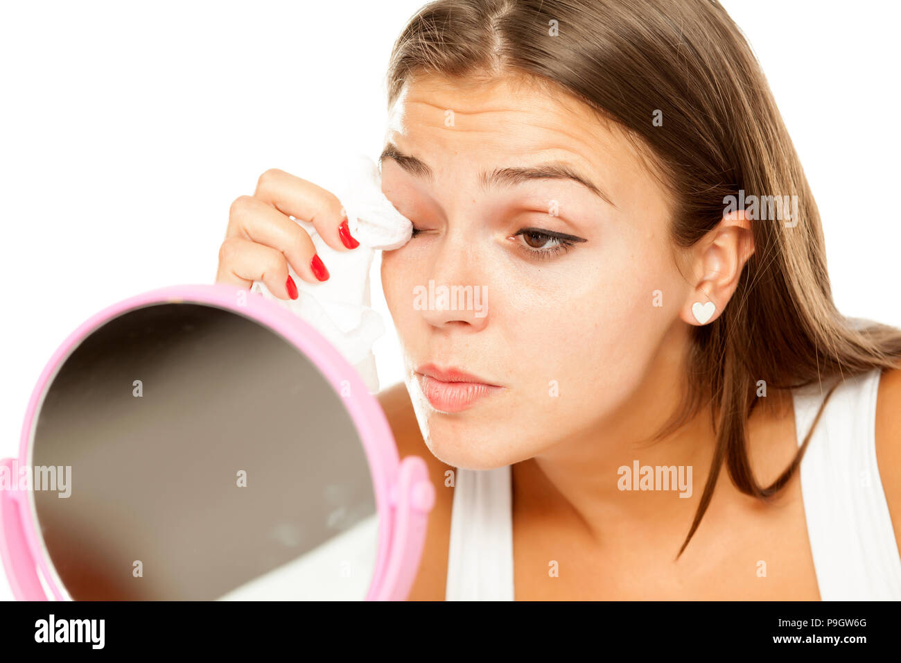 young beautiful woman removing makeup from her face Stock Photo - Alamy