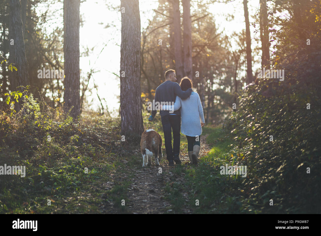 People and dogs. Young couple enjoying nature outdoors together with ...