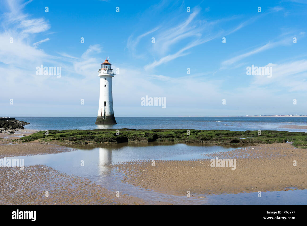 New Brighton Lighthouse, Wirral, UK, at the seaside with blue sky and ...