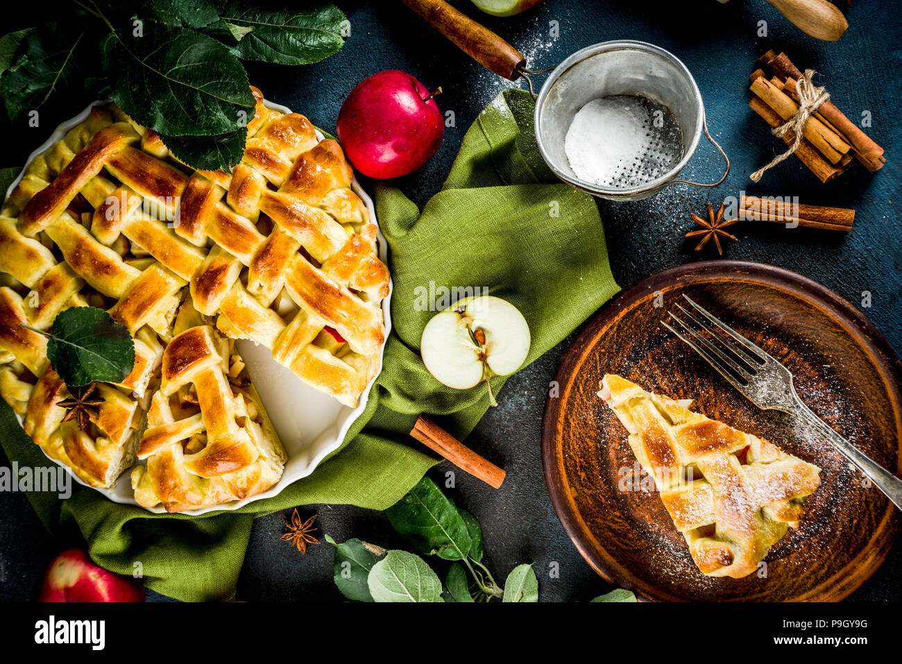 Traditional autumn baking, homemade apple pie with cinnamon, dark blue ...