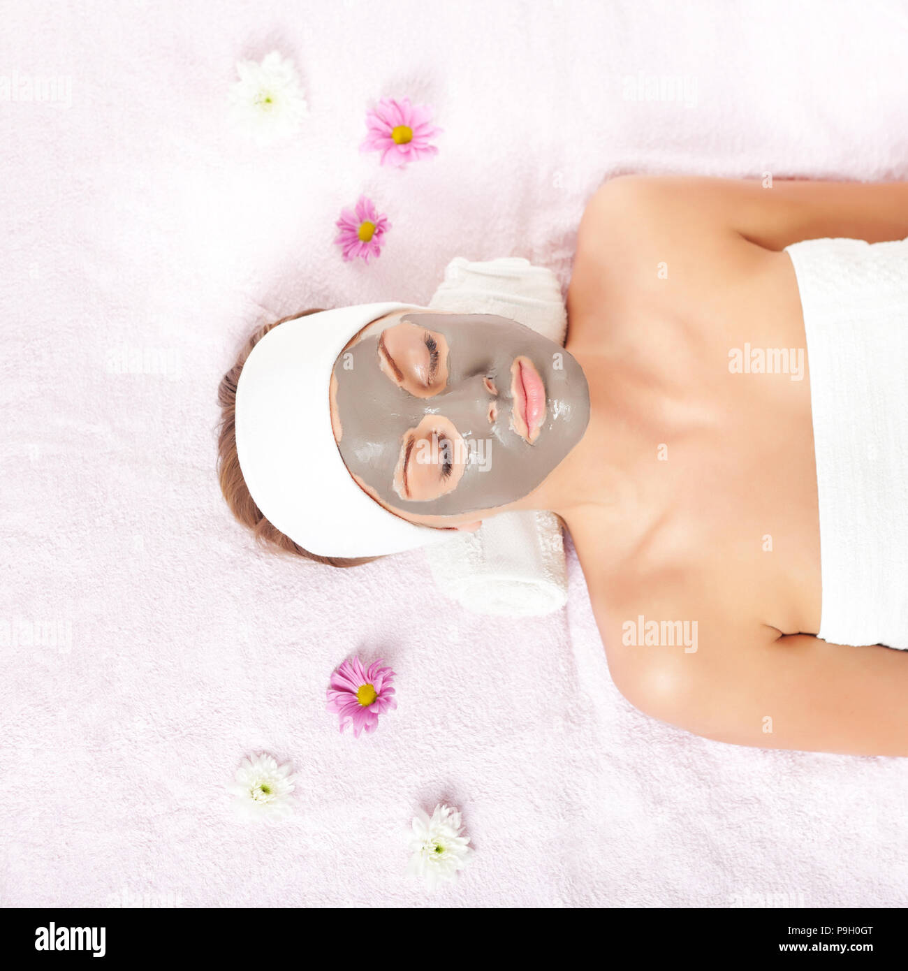 Young woman with clay skin mask on her face Stock Photo - Alamy
