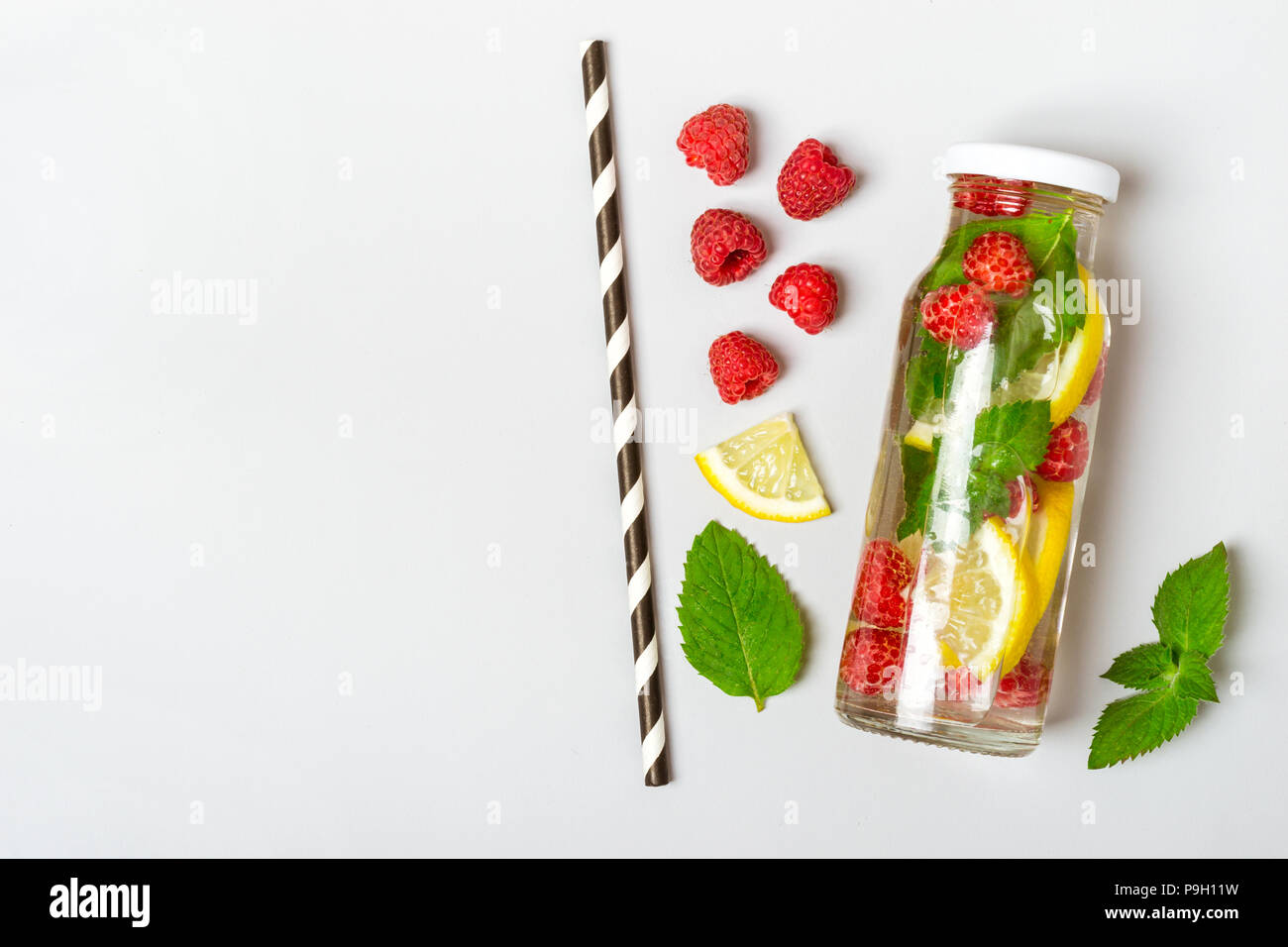 Raspberries lemon lemonade in a bottle and ingredients Stock Photo - Alamy