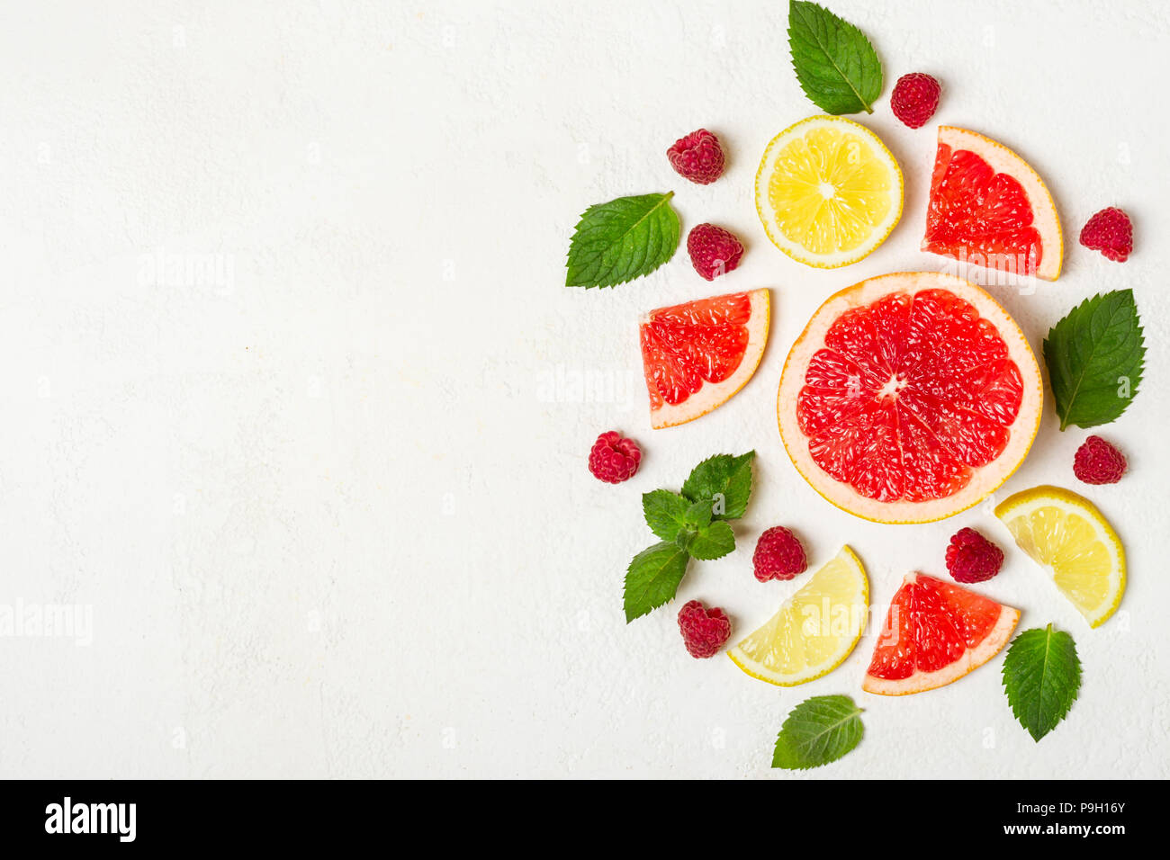 Citrus, raspberry and mint on white. Health detox concept Stock Photo ...