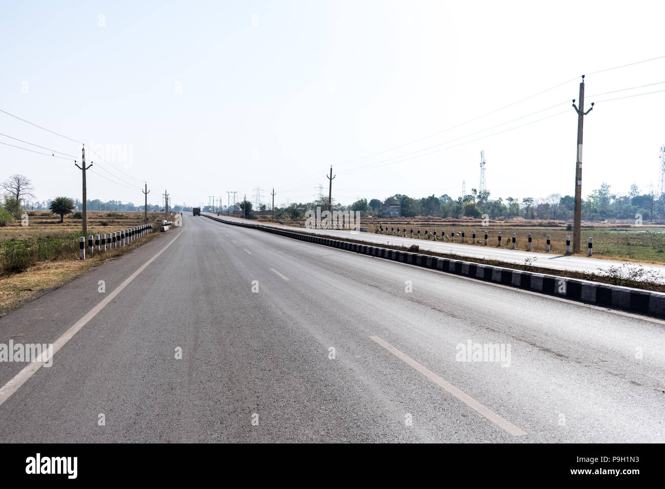 Empty Two way Road of Indian small town straight line in sunny day in ...